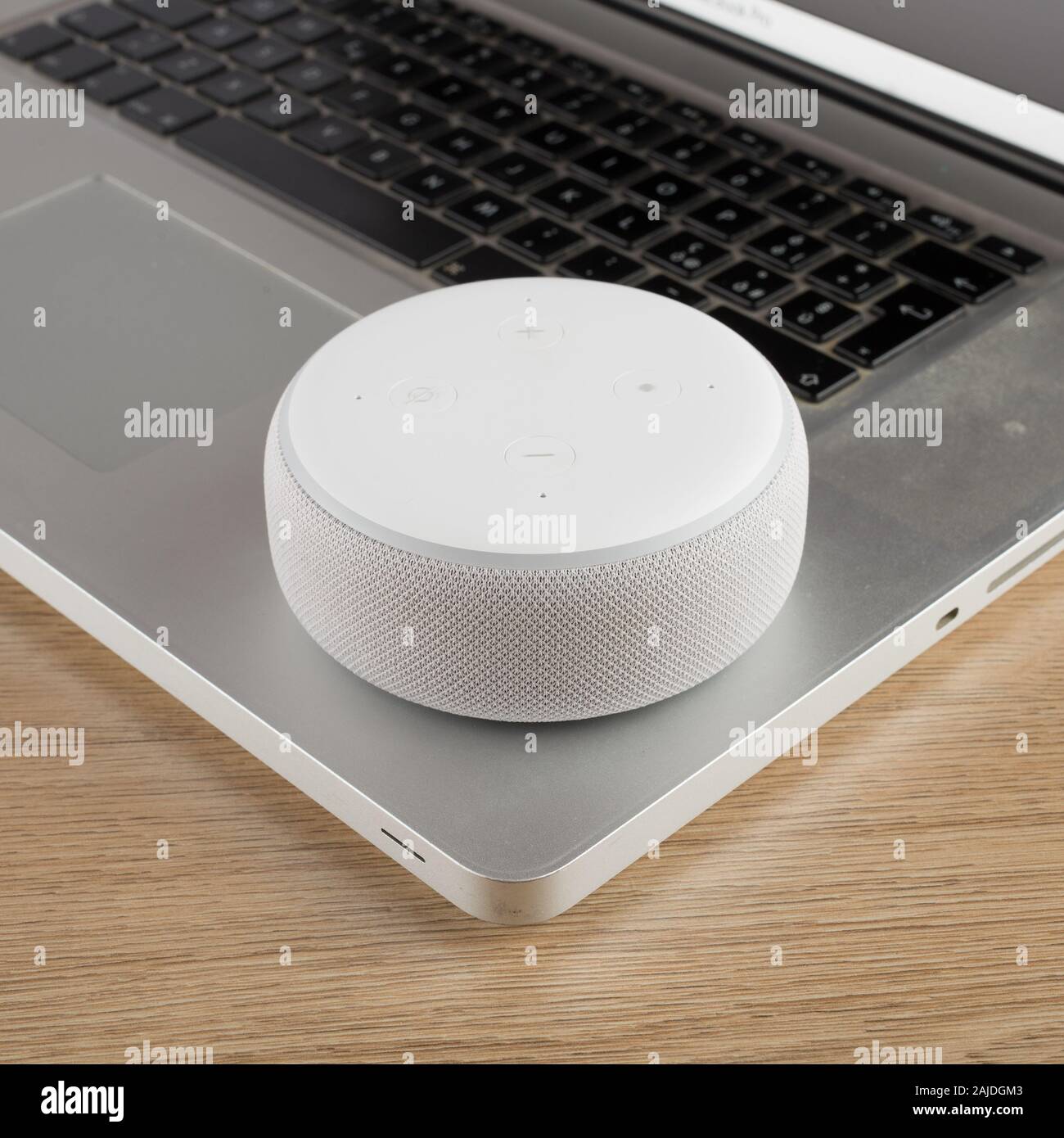 digital voice assistant on wooden table with computer Stock Photo - Alamy