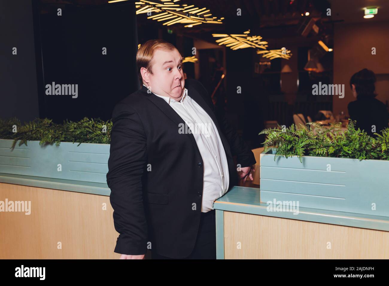 fat man stuck between furniture because of his big belly Stock Photo ...