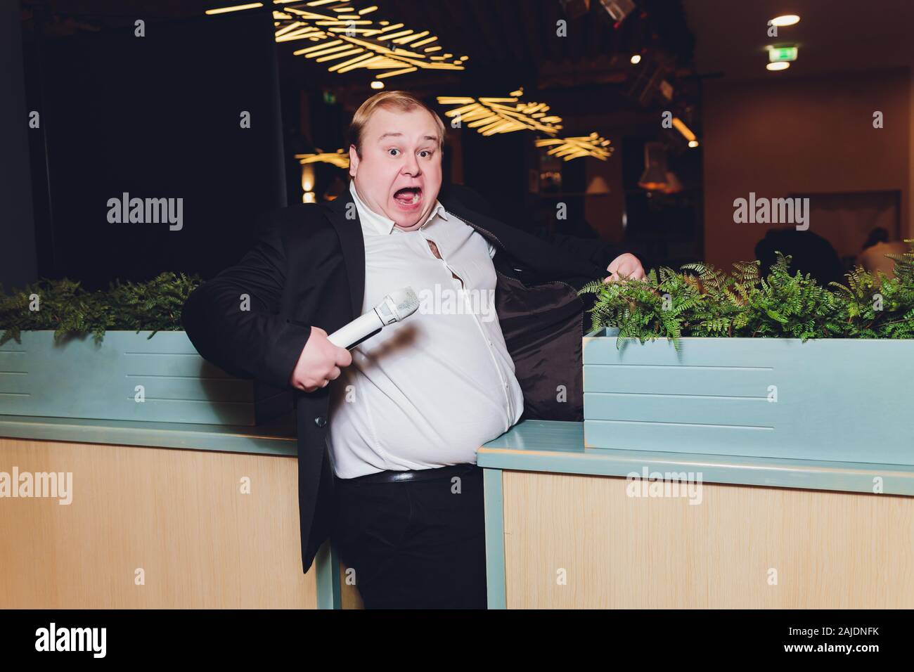 fat man stuck between furniture because of his big belly Stock Photo ...