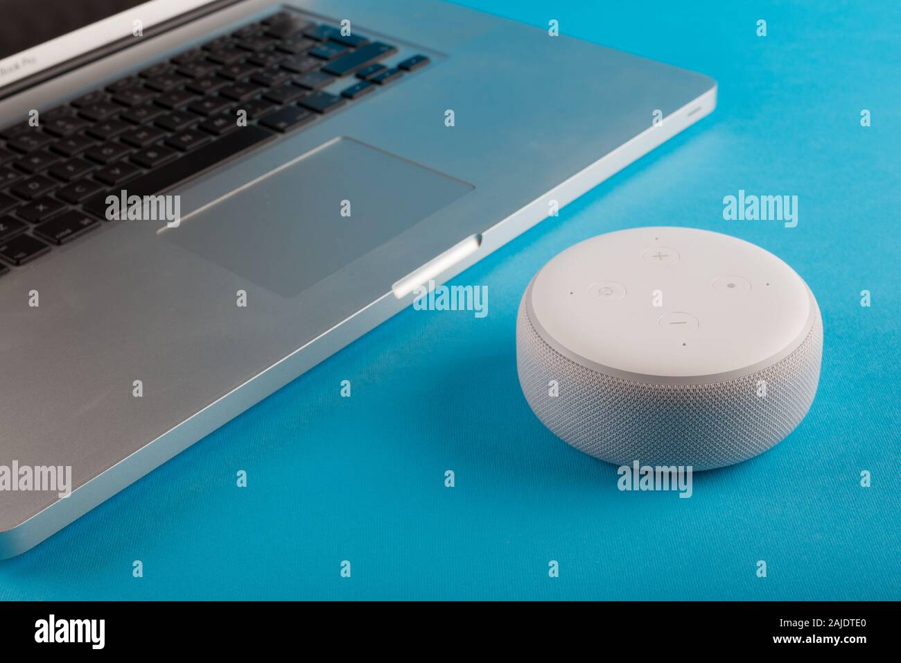 white digital voice assistant with computer on light blue background ...