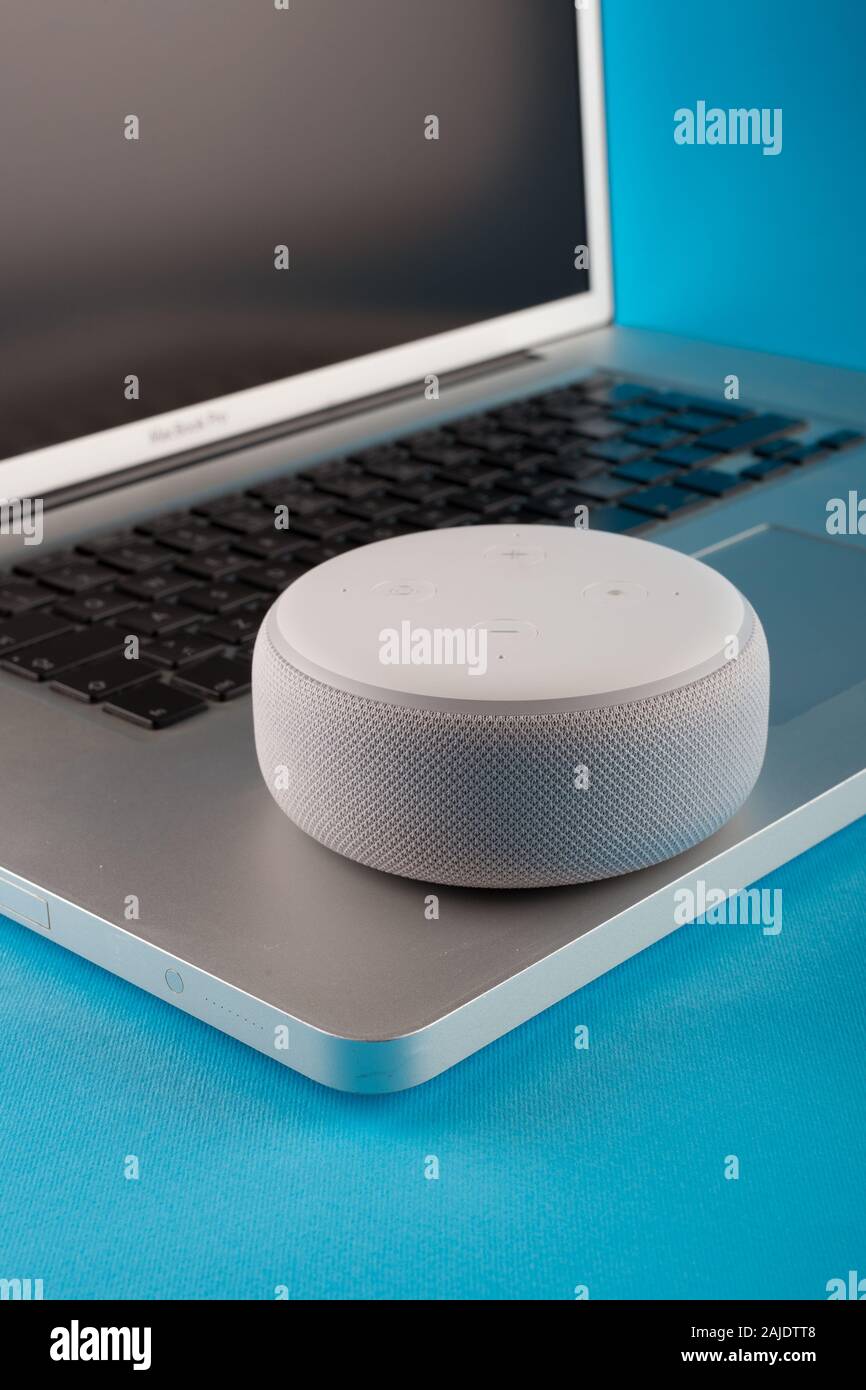 white digital voice assistant with computer on light blue background ...