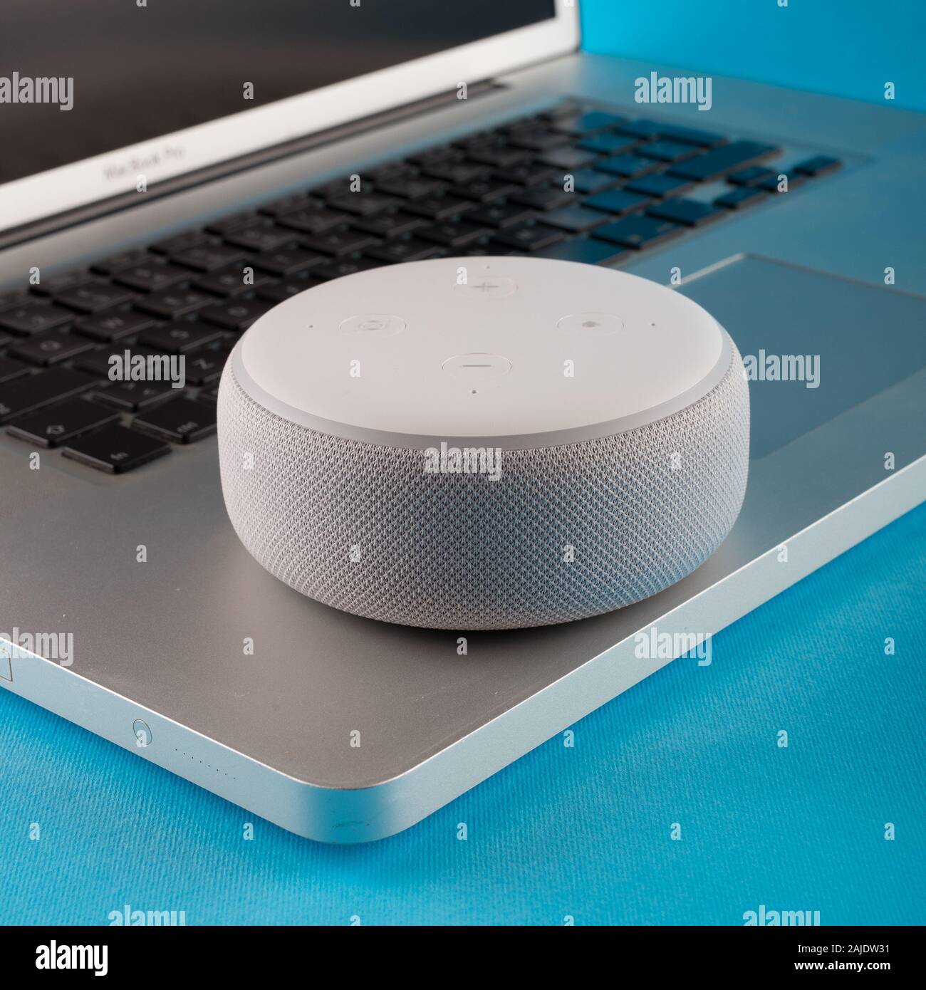 white digital voice assistant with computer on light blue background ...