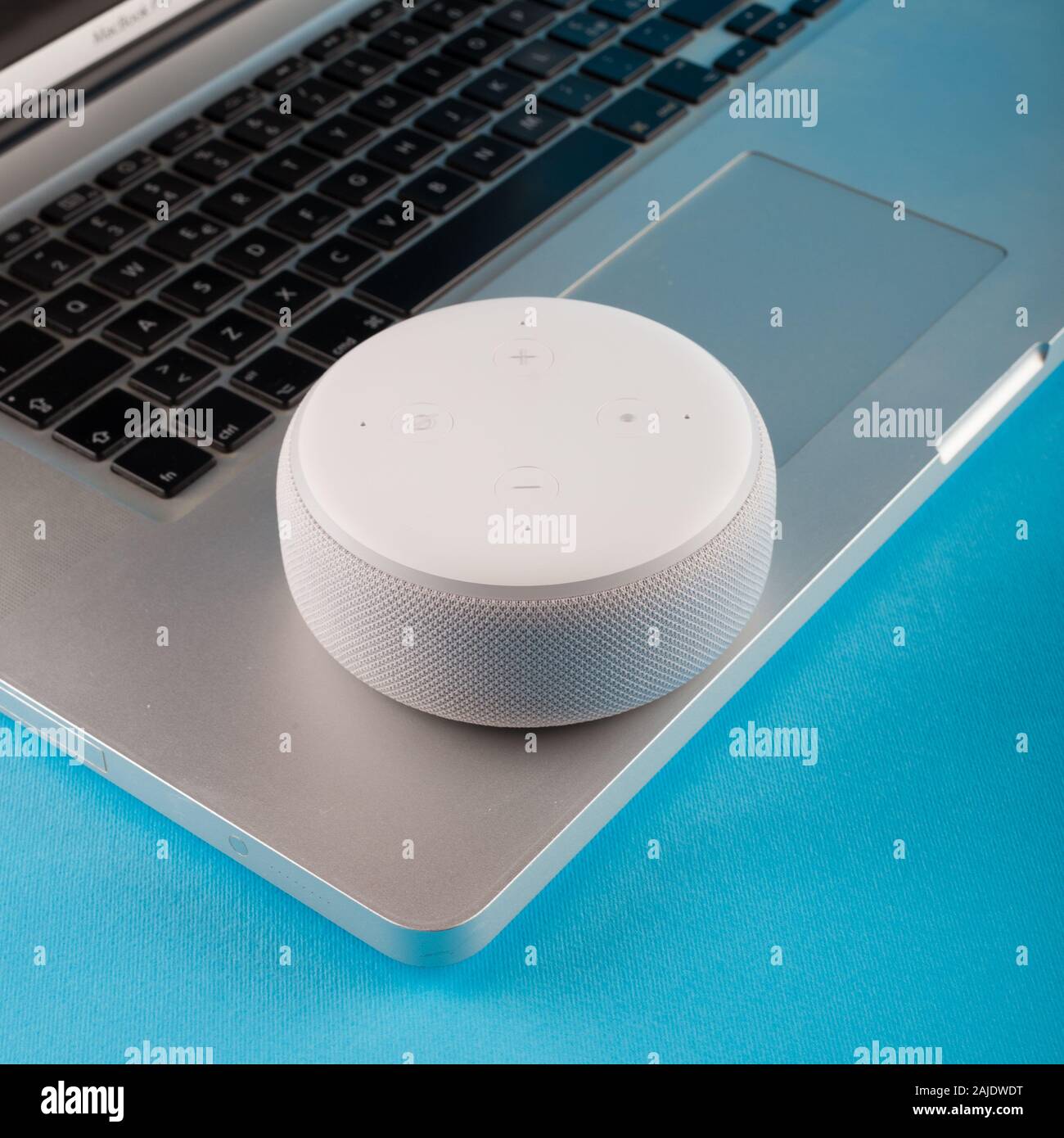 white digital voice assistant with computer on light blue background ...