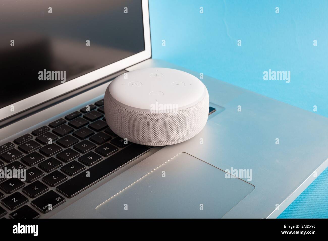 white digital voice assistant with computer on light blue background ...