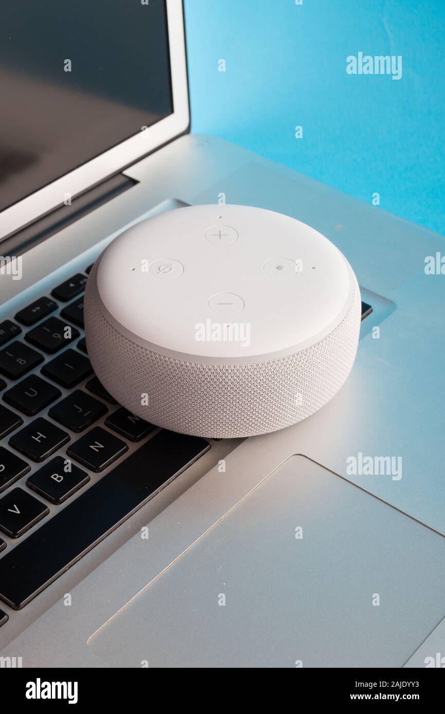 white digital voice assistant with computer on light blue background ...
