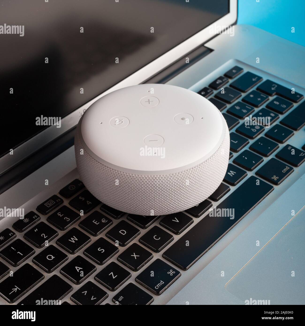 white digital voice assistant with computer on light blue background ...