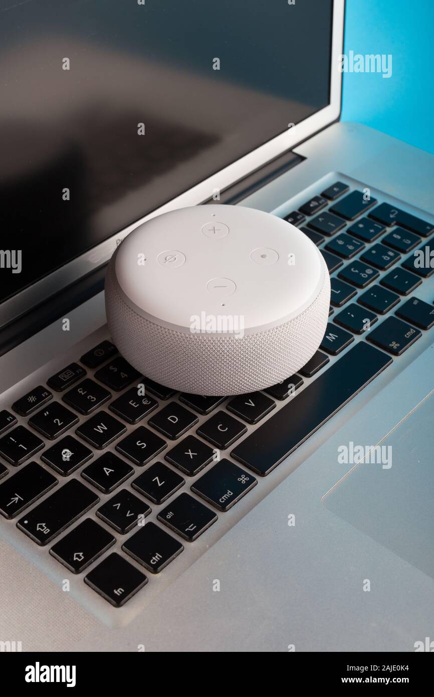 white digital voice assistant with computer on light blue background ...