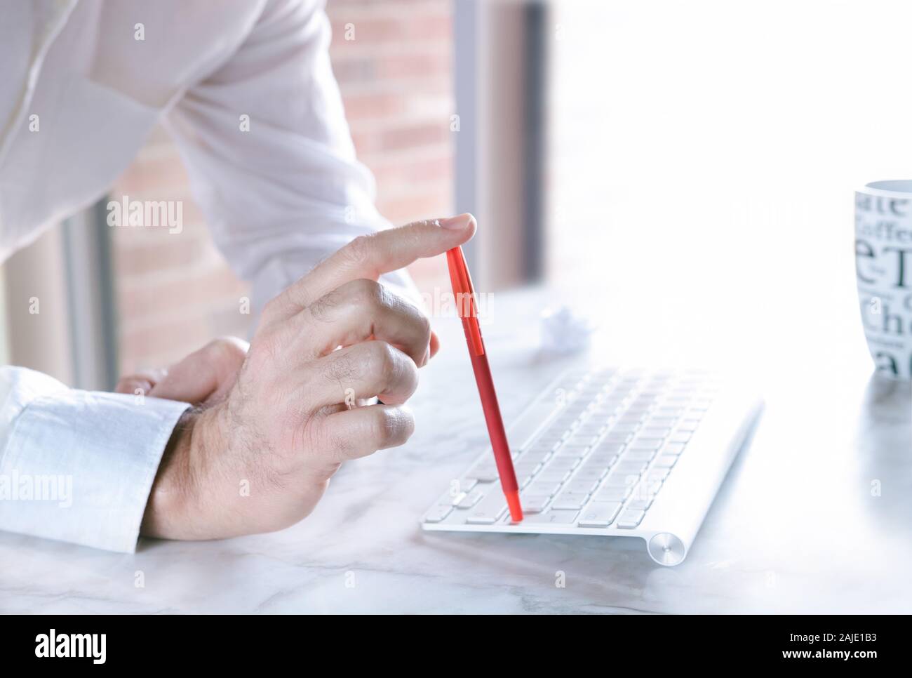 Man's hand pushes the ENTER button with his pen Stock Photo - Alamy