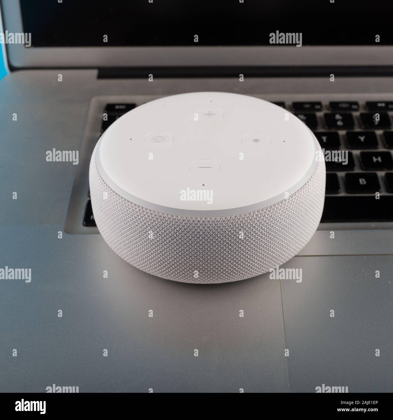 white digital voice assistant with computer on light blue background ...