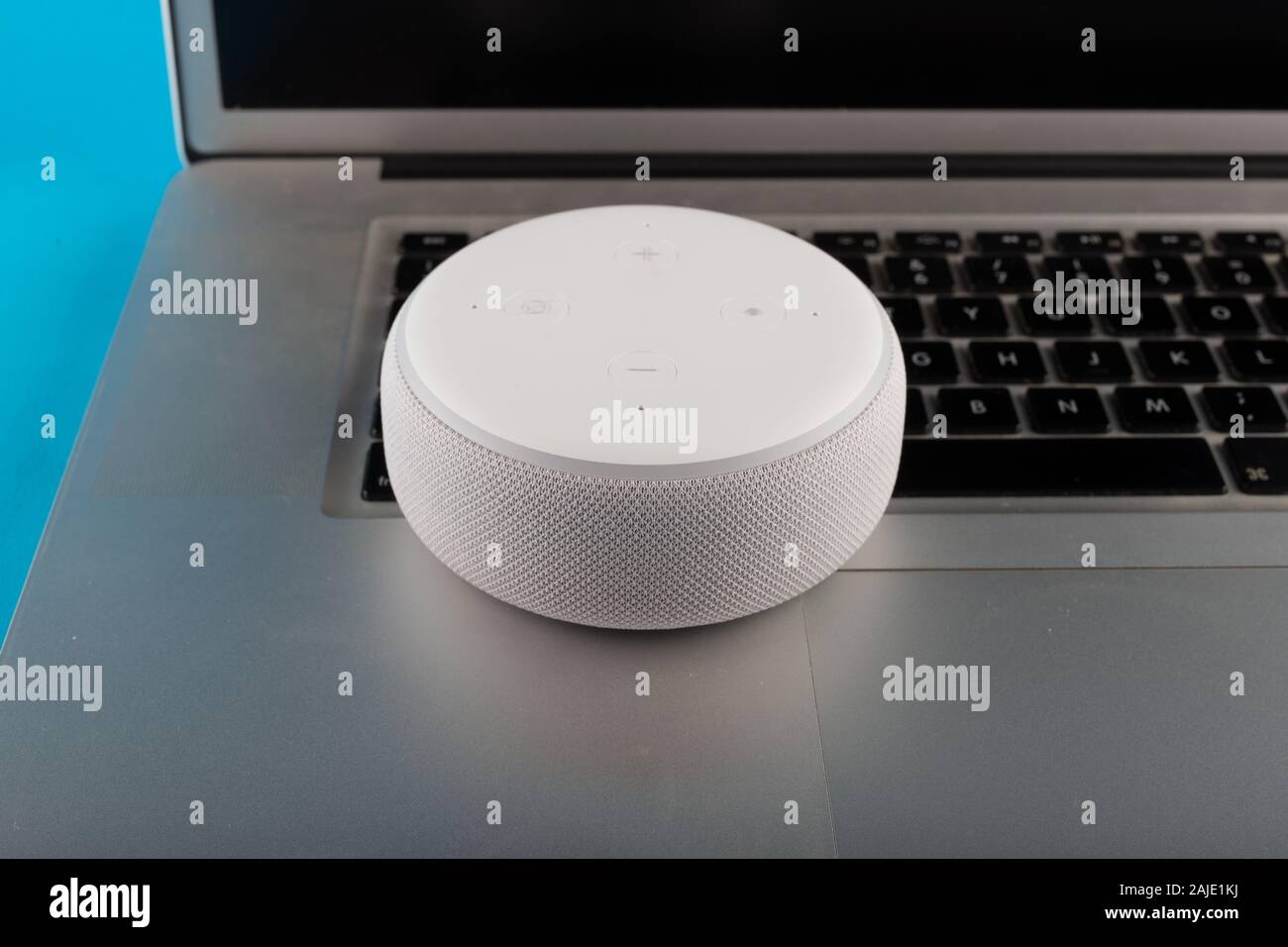 white digital voice assistant with computer on light blue background ...