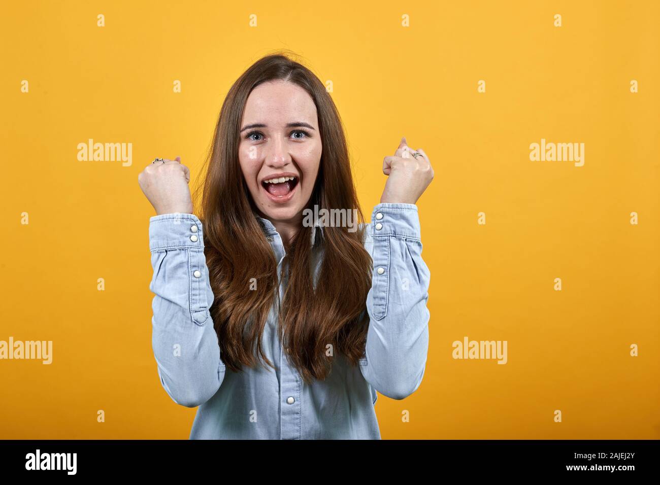 Cheerful woman screaming, dancing, waving fists, smiling Stock Photo ...