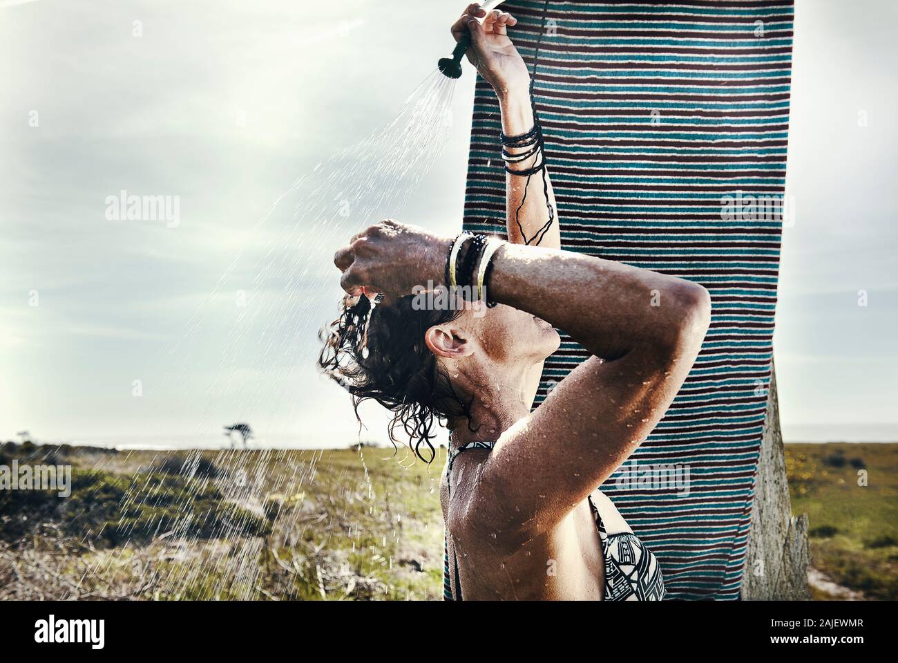 woman surfer uses longboard as shower Stock Photo - Alamy