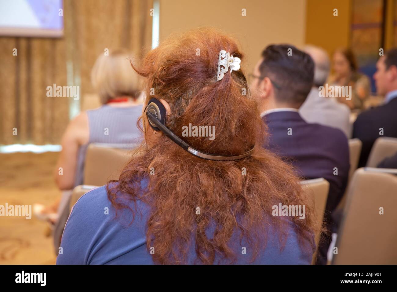 Unrecognizable man using headphones for translation during video ...