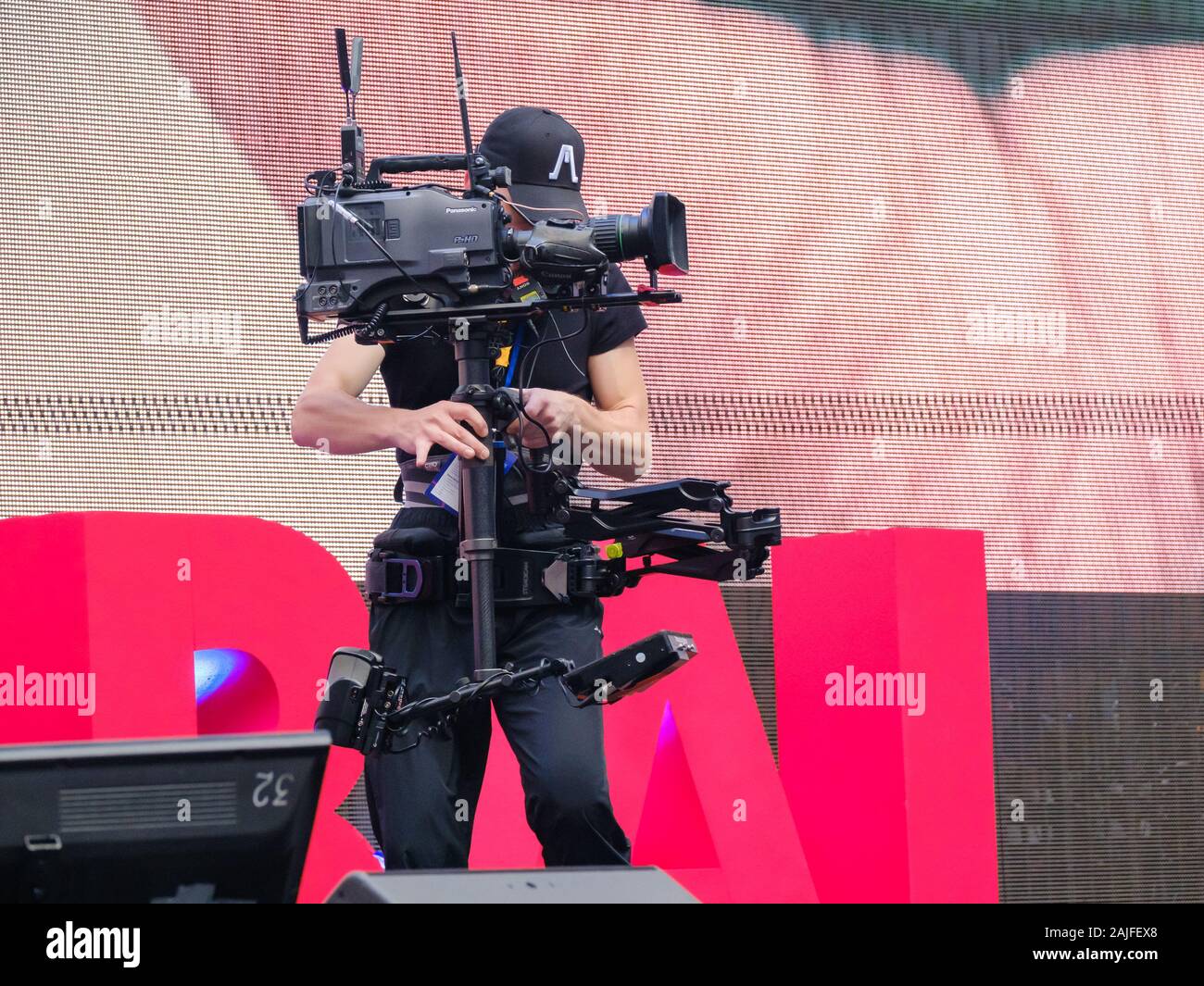 Steadicam camera man online broadcasting from stage Stock Photo - Alamy