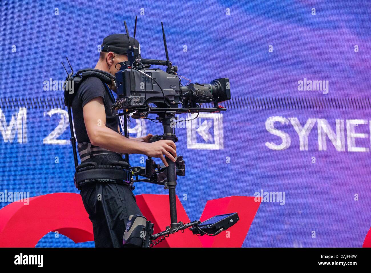 Steadicam camera man online broadcasting from stage Stock Photo - Alamy