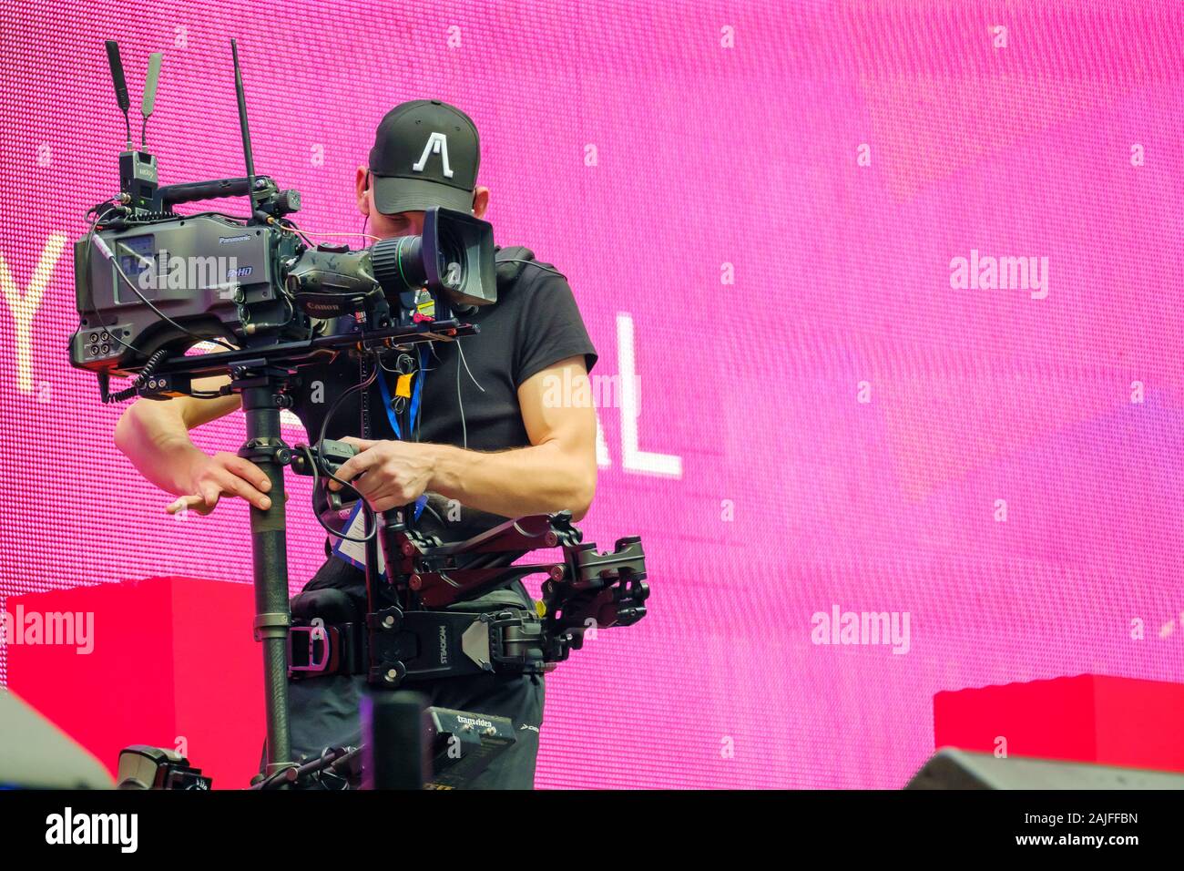 Steadicam camera man online broadcasting from stage Stock Photo - Alamy