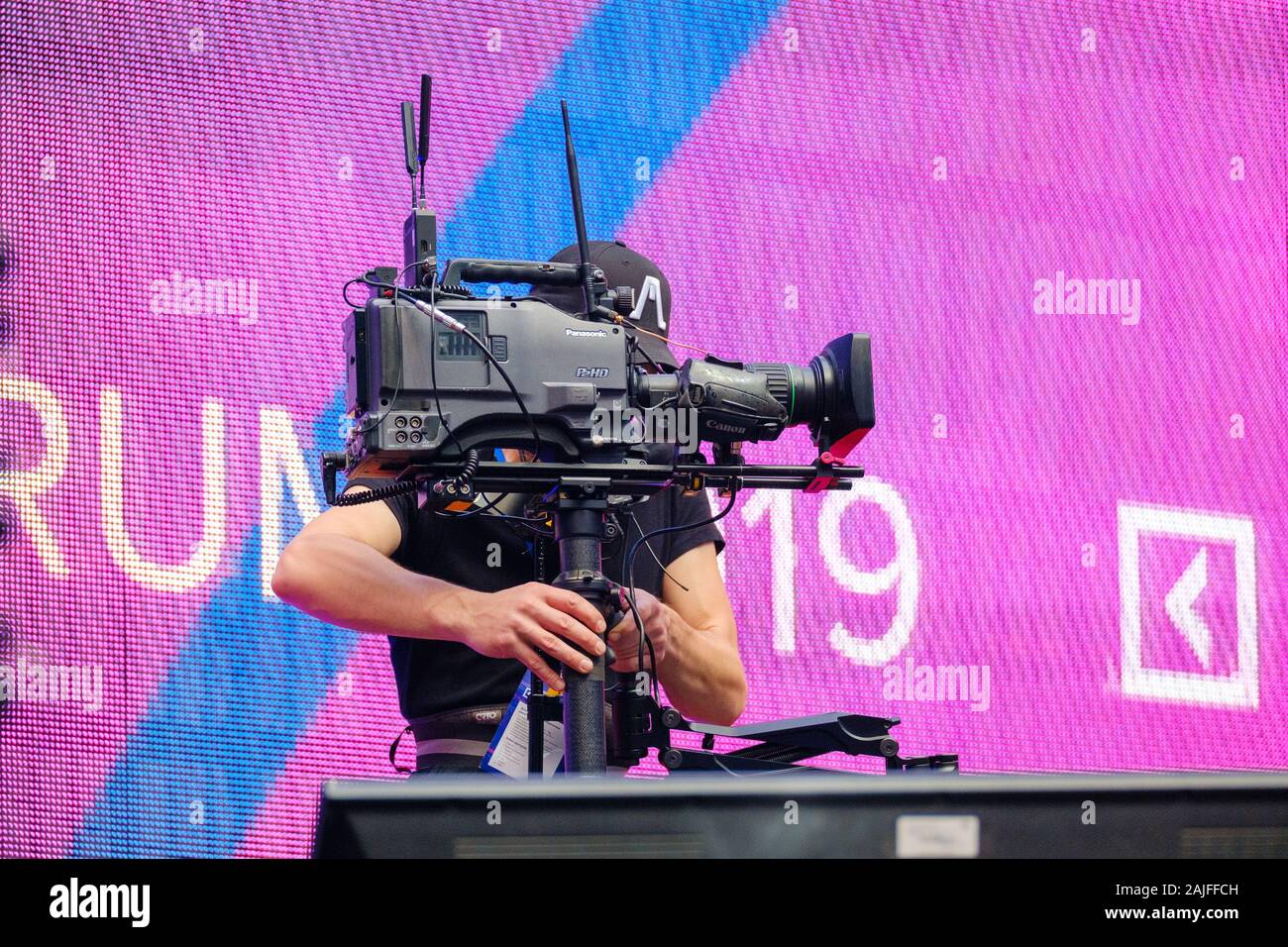 Steadicam camera man online broadcasting from stage Stock Photo - Alamy