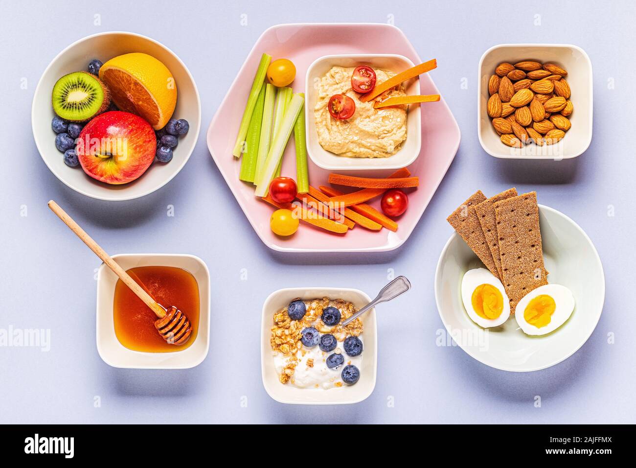 Healthy snack on a pastel background, top view Stock Photo - Alamy