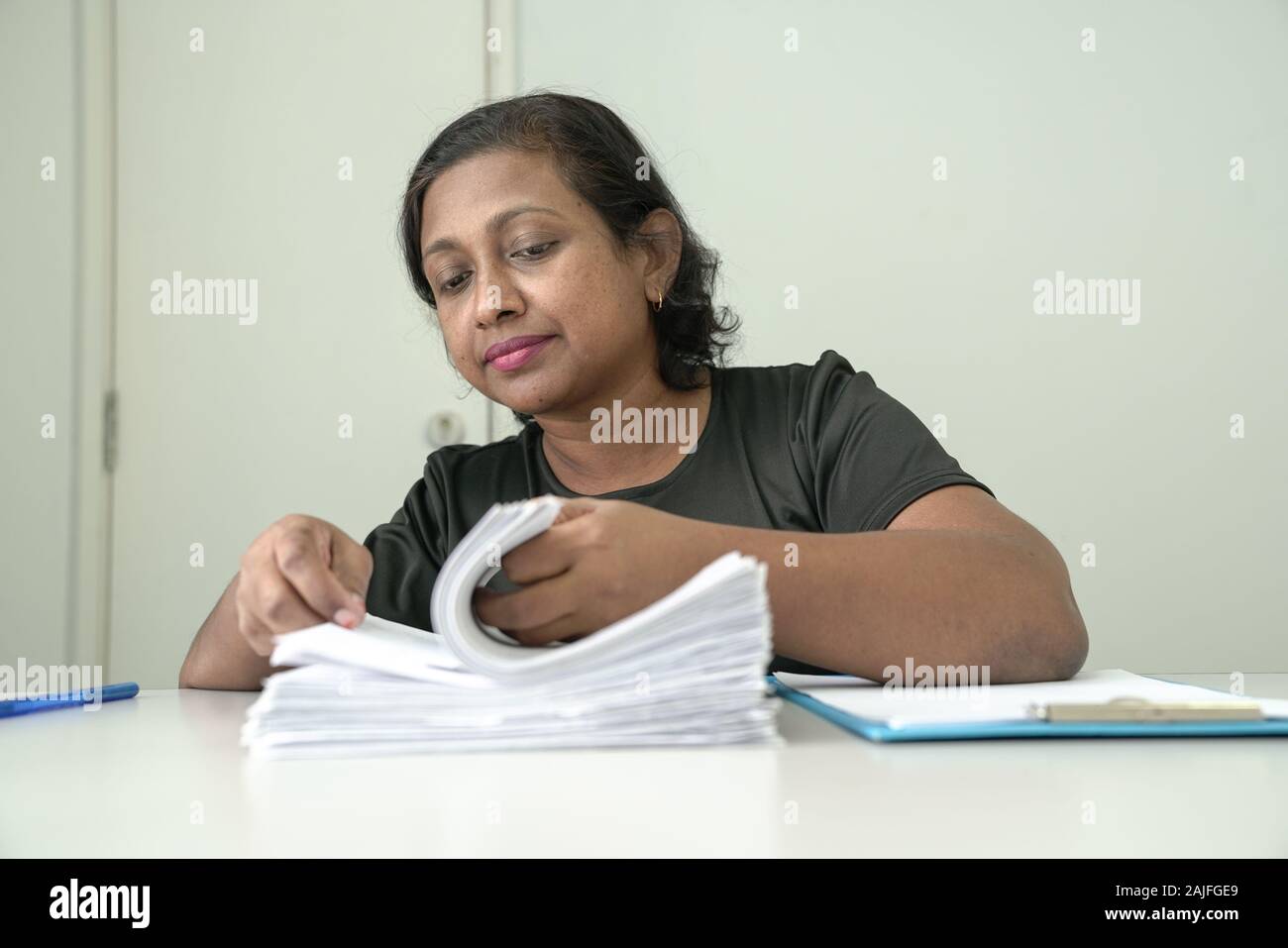 Female executive flipping through hi-res stock photography and images ...