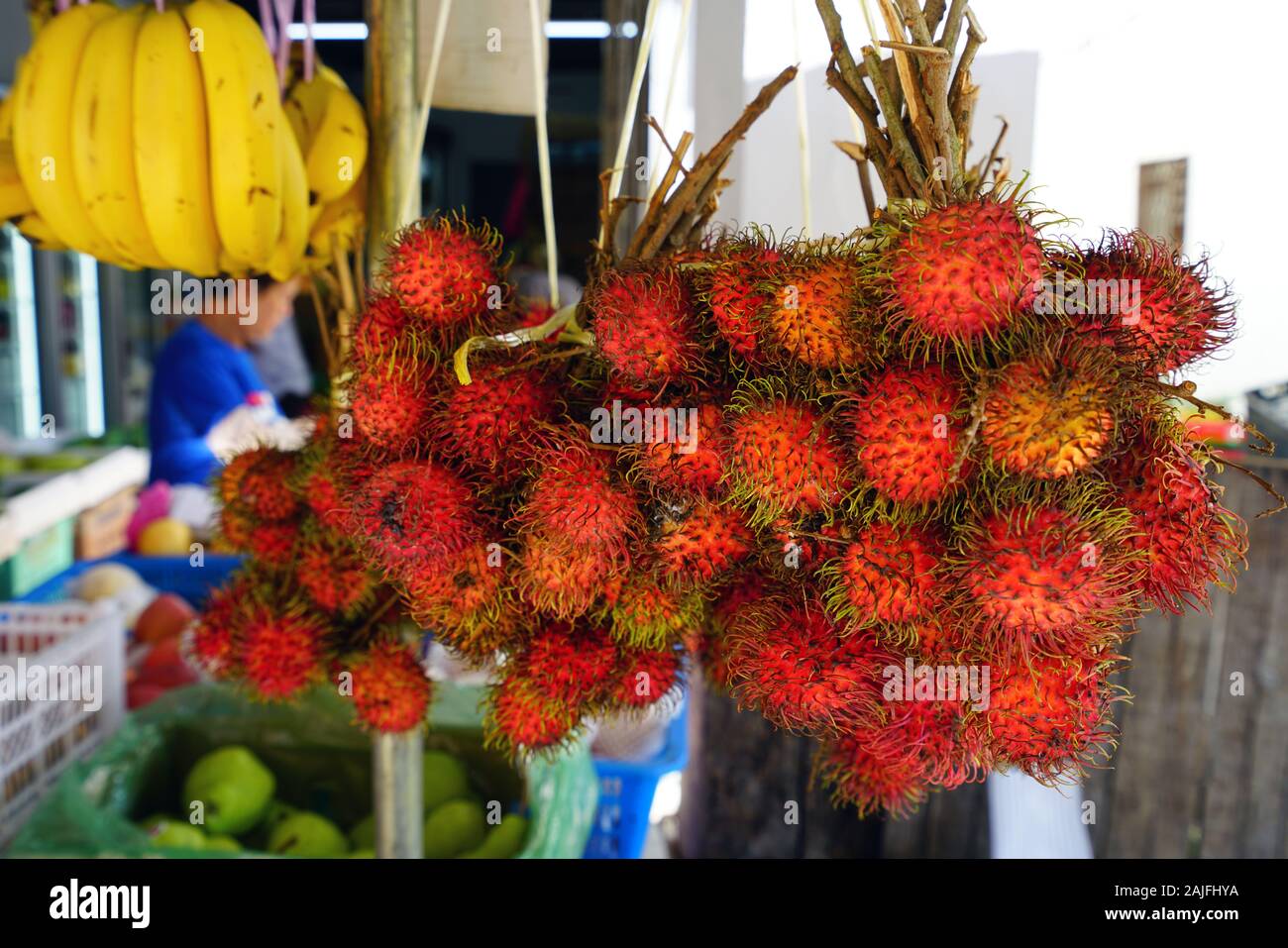 Bunches of spiky red rambutan at a street market in Malaysia Stock ...