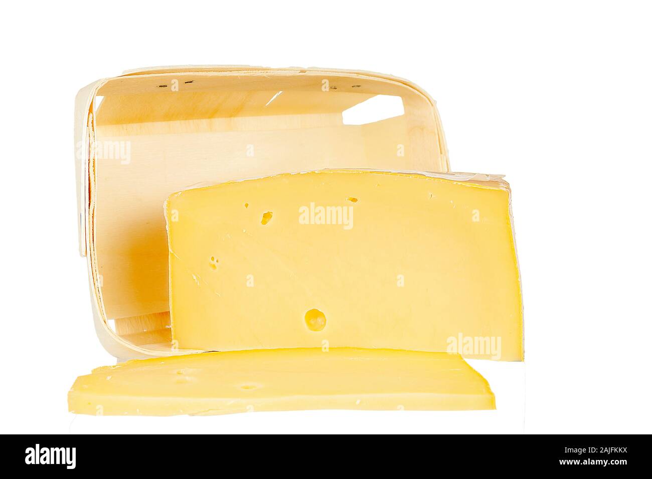 Cheese lies in birch bark packaging on a white background, isolate ...