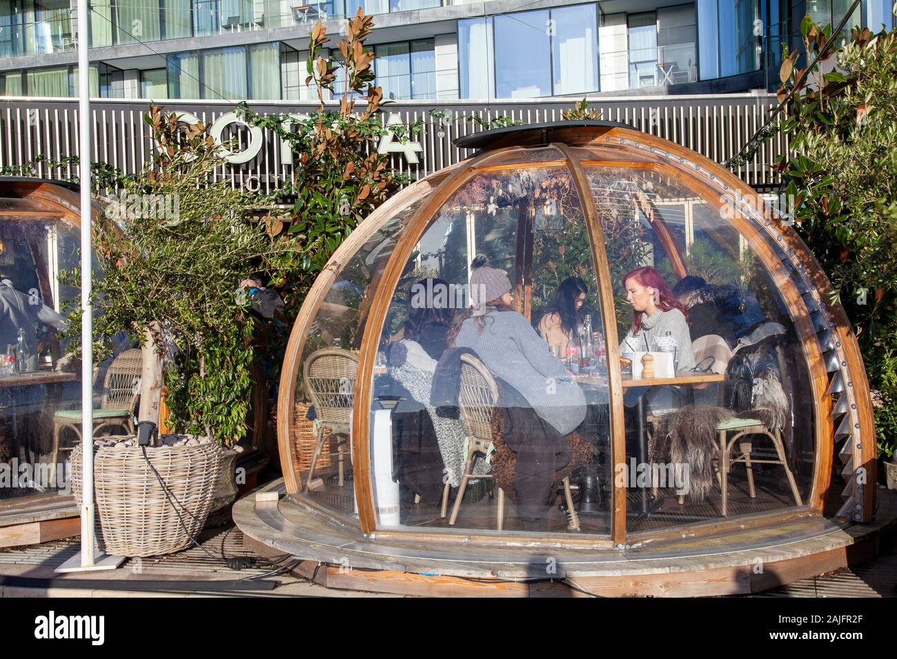 Diners in Coppa Club Igloos on Three Quays Walk , London UK EC3R Stock ...
