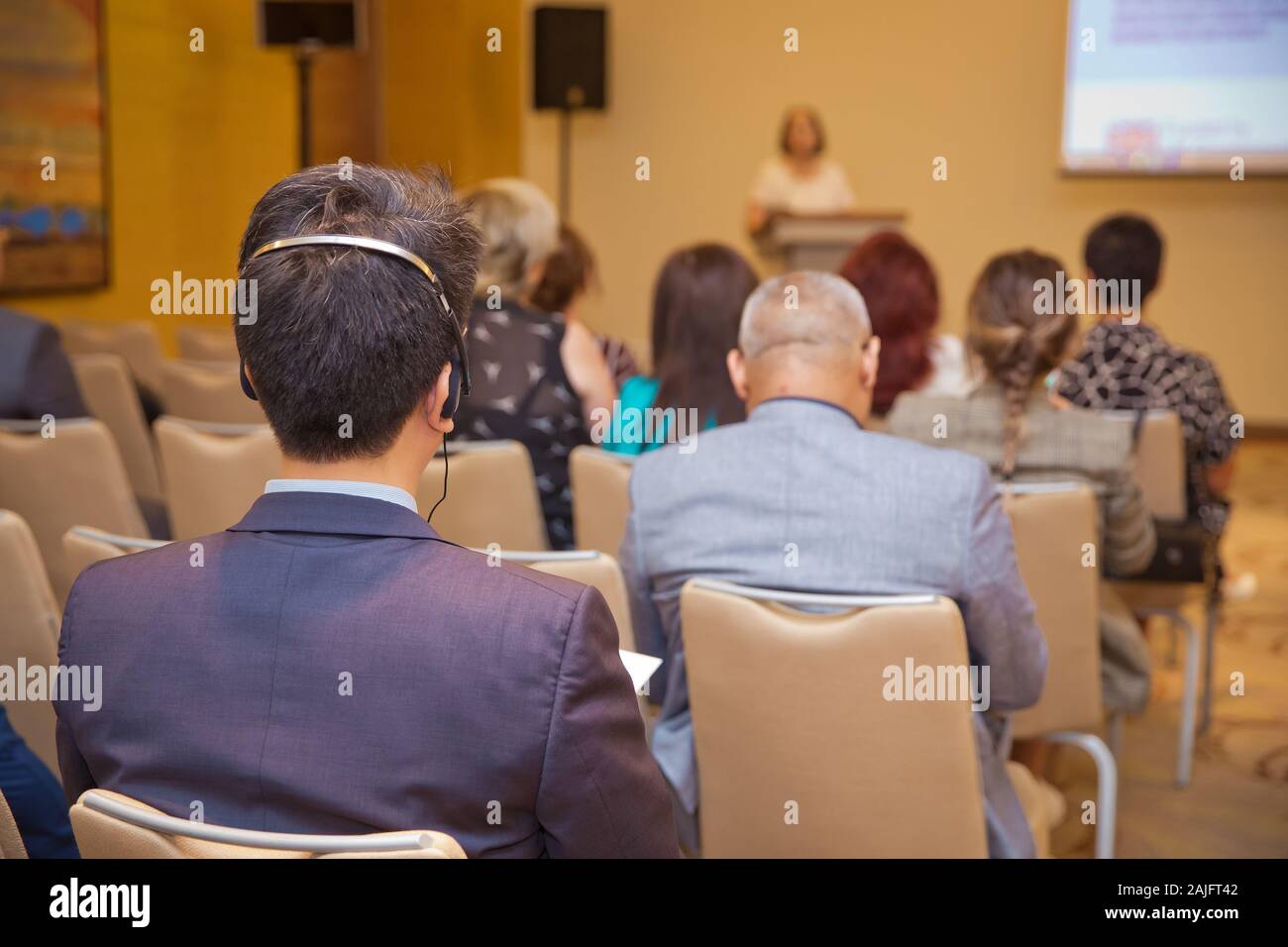 Unrecognizable man using headphones for translation during video ...