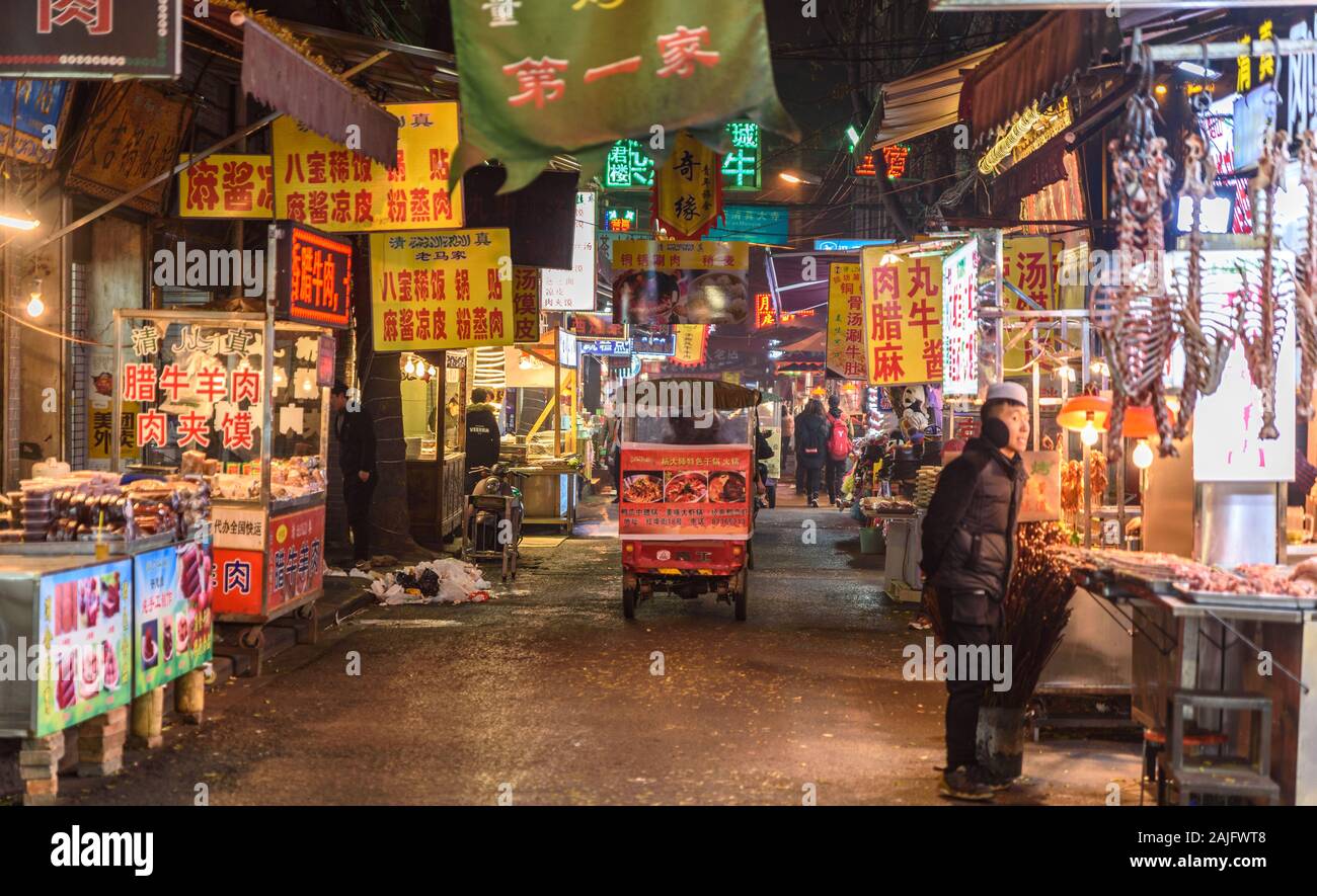 Xi’an, China: Shops and illuminated signboards by night in a ...