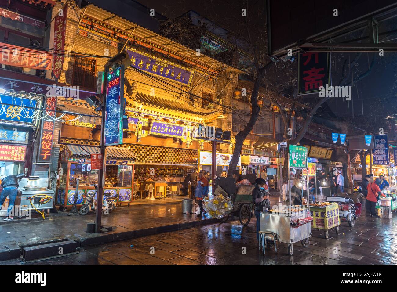 Xi’an, China: Shops and illuminated signboards by night in a ...