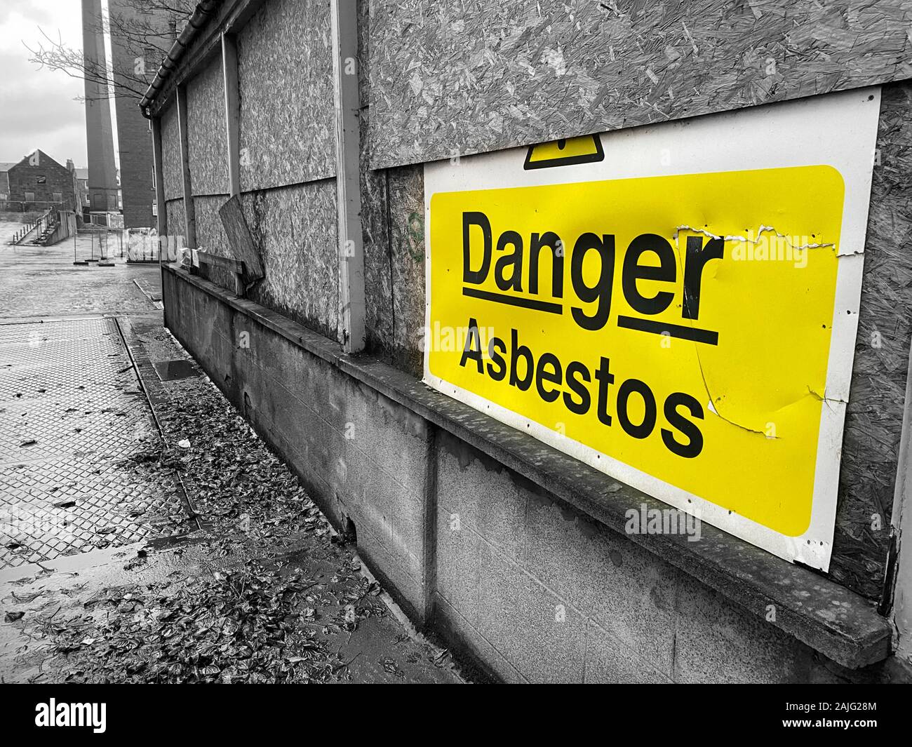 Asbestos danger sign at building construction site refurbishment of old ...