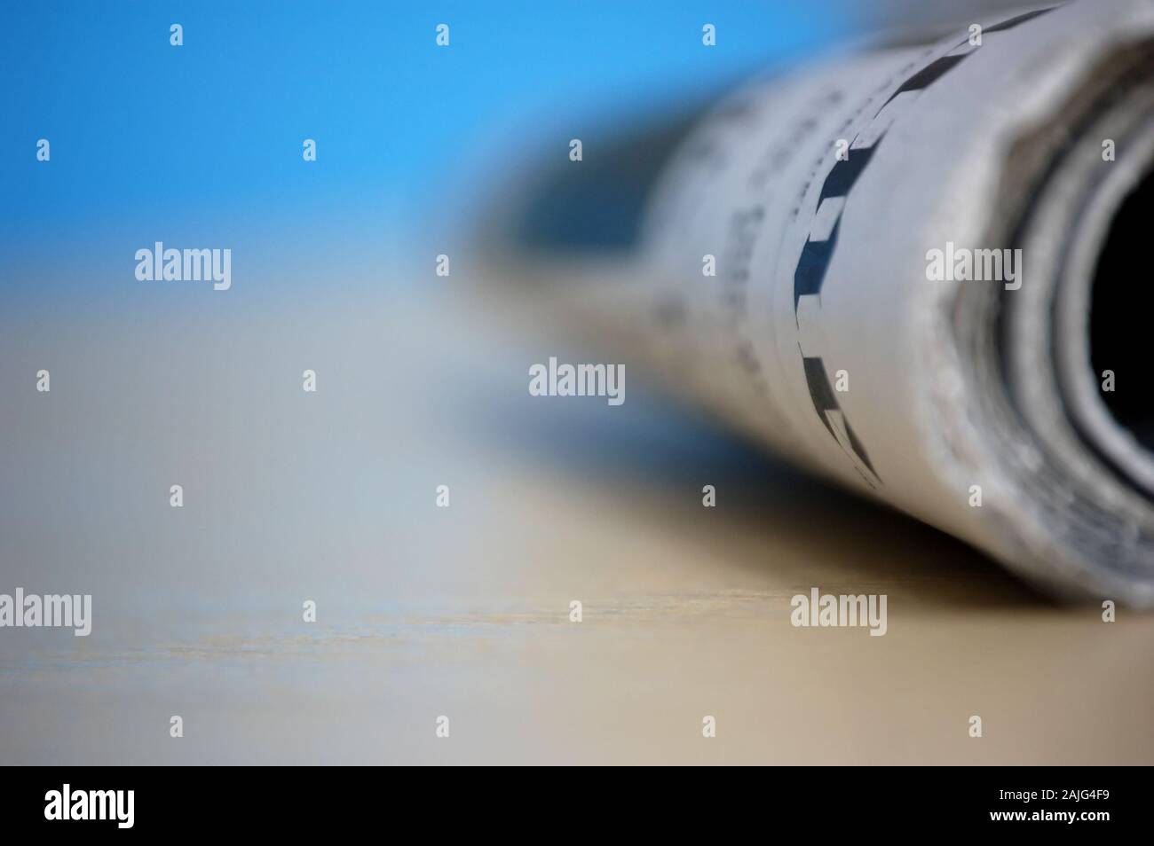 close up of a rolled newspaper Stock Photo - Alamy