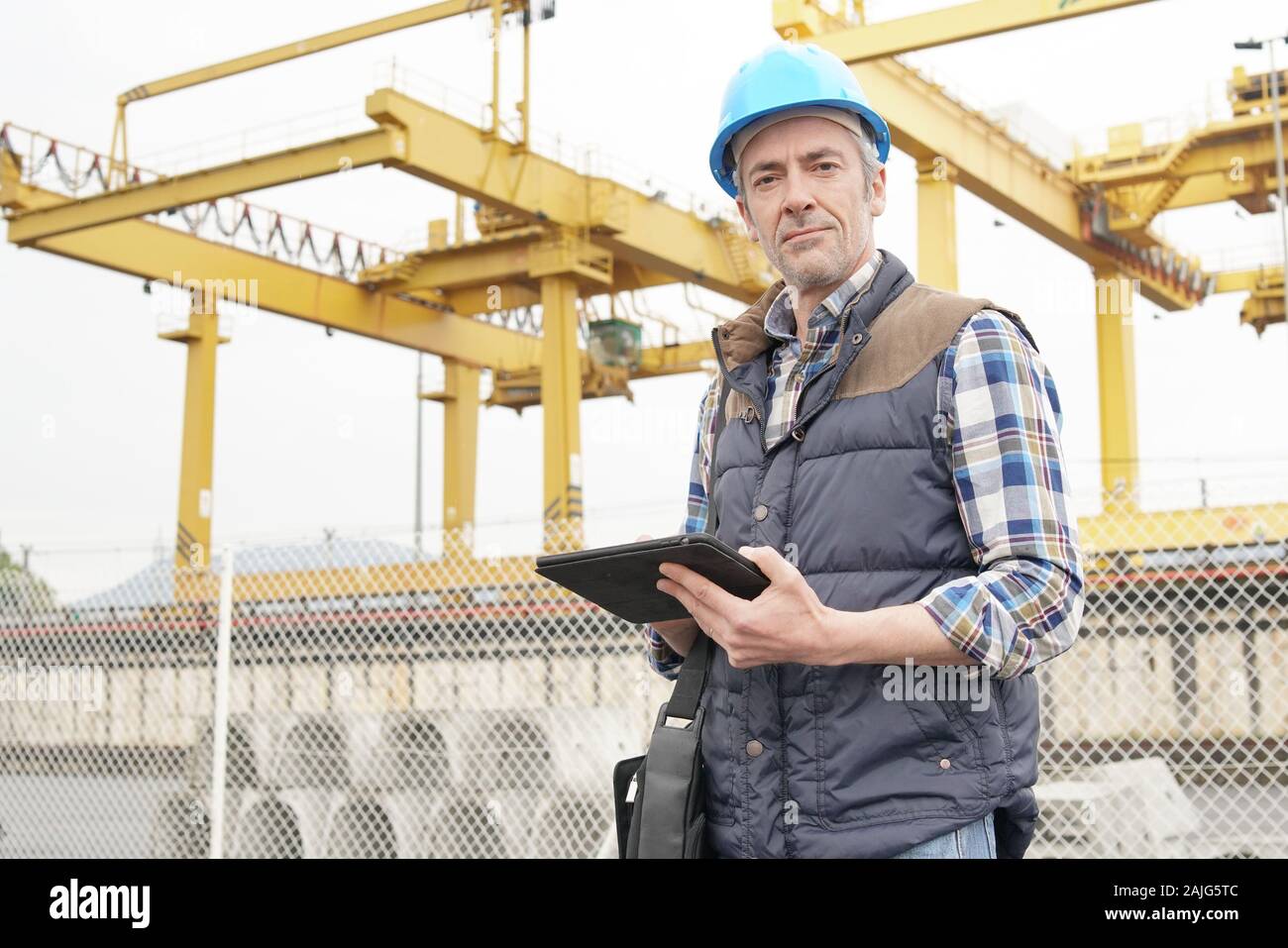 Mature construction worker inspecting work sight Stock Photo - Alamy