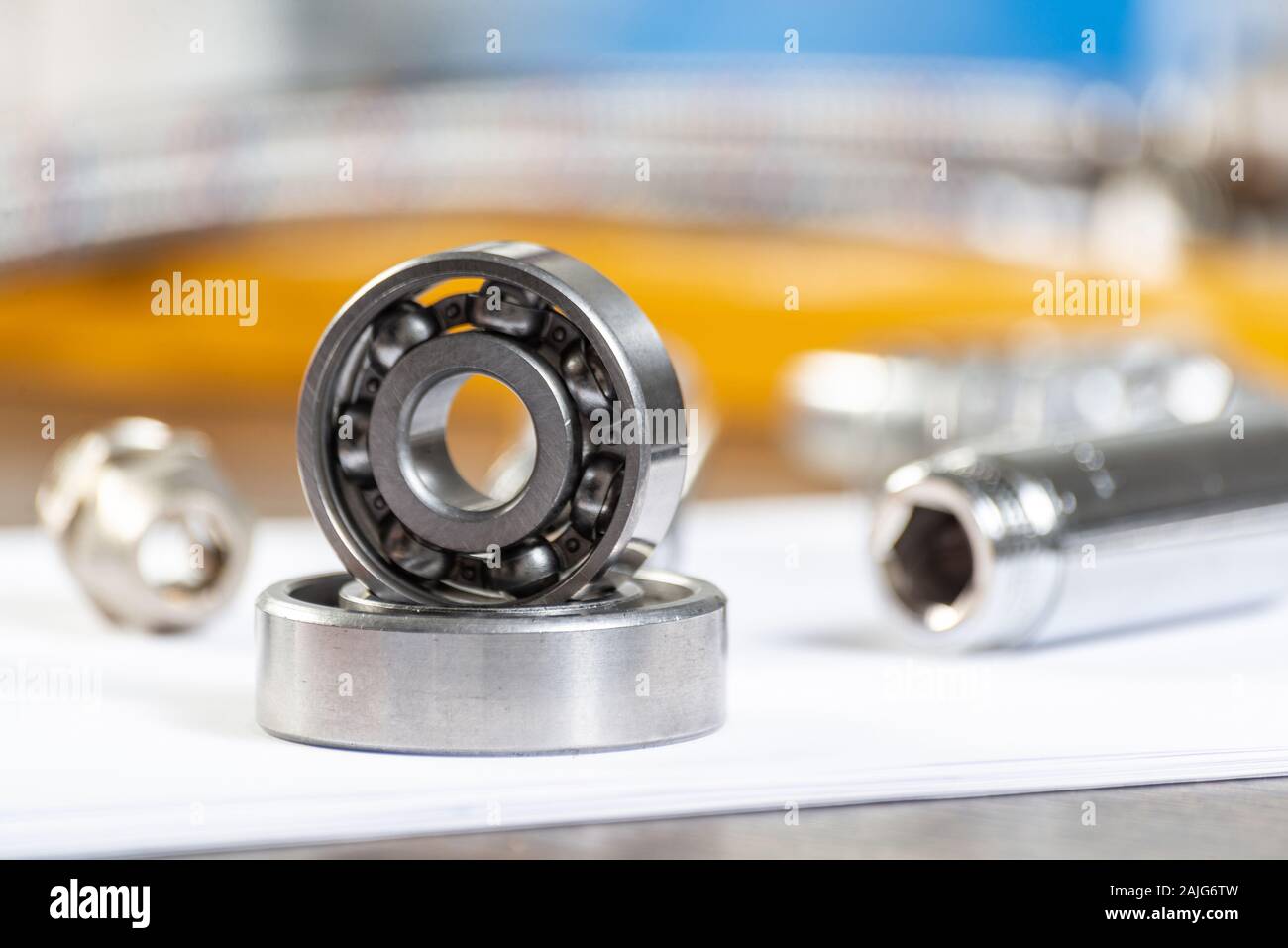 Plumbing pipeline and ball bearings laying on table. Water fittings and ...