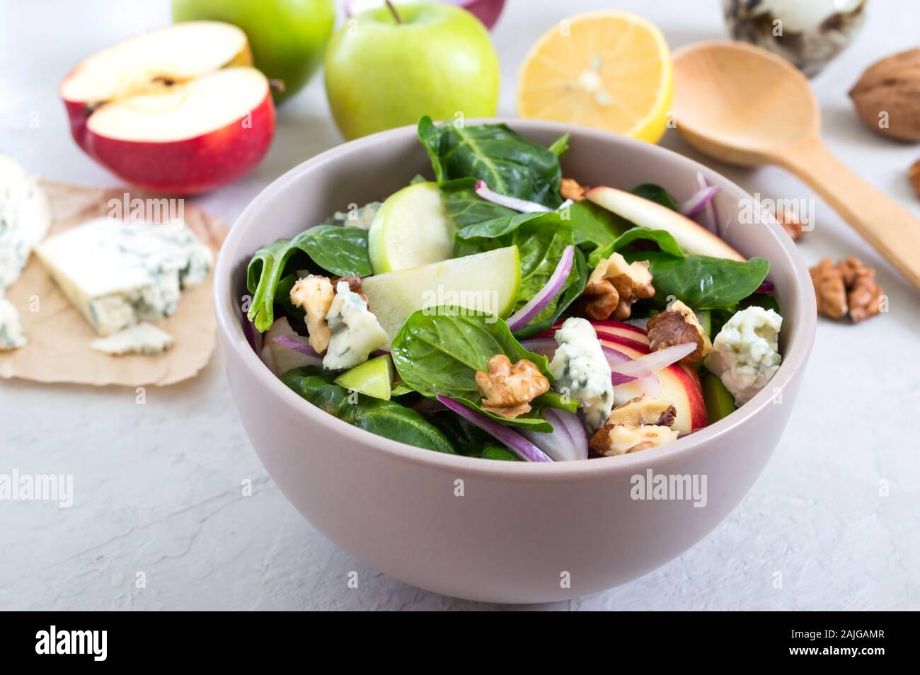 Delicious diet fitness salad with spinach, apples, red onions, blue ...