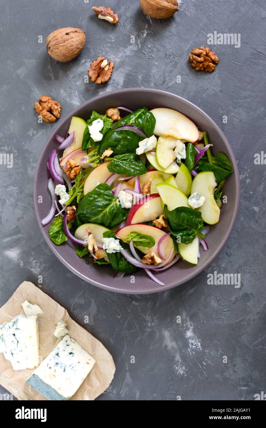 Tasty diet fitness salad with spinach, apples, red onions, blue cheese ...