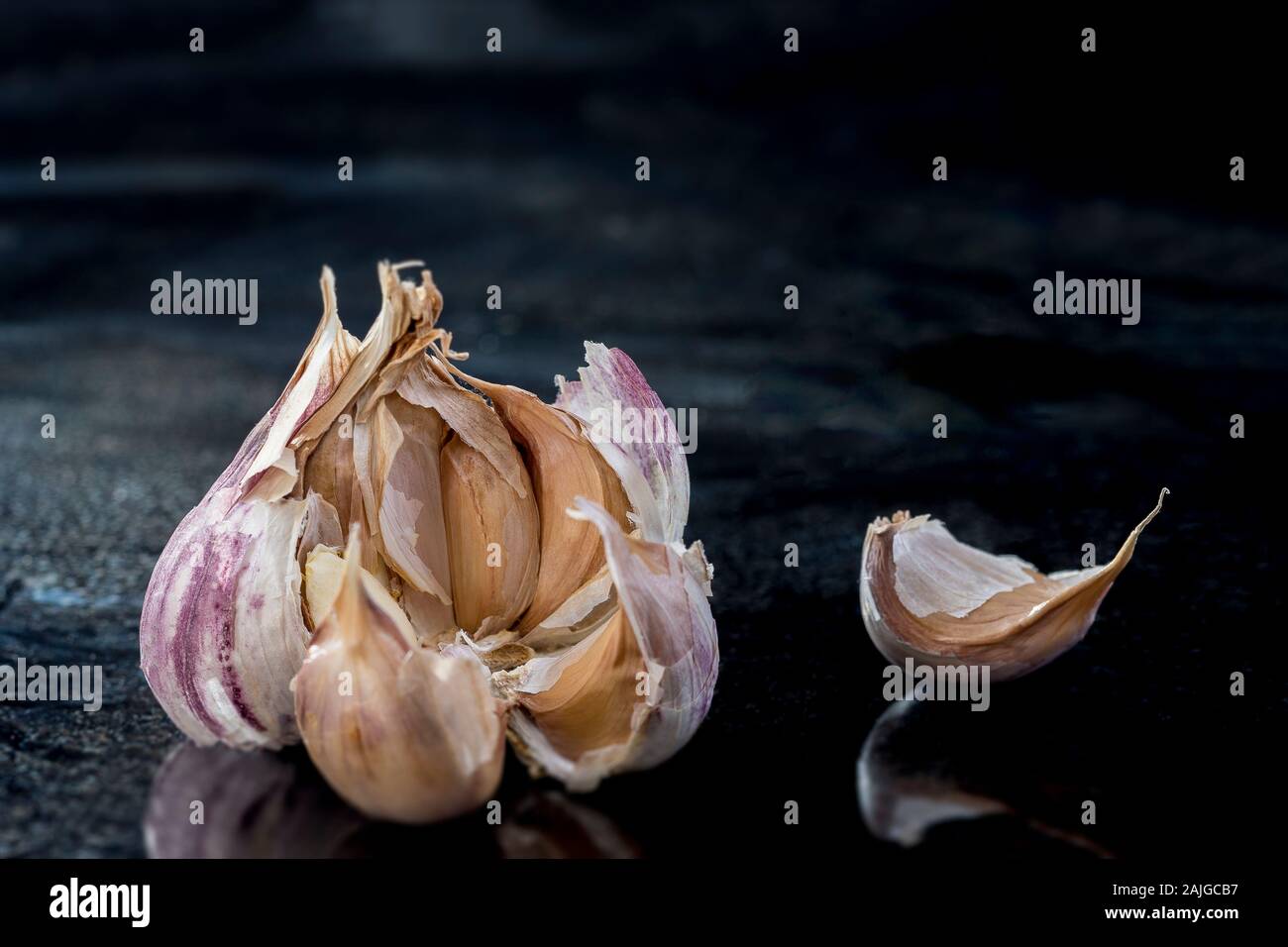 Whole garlic bulb close-up isolated on black background Stock Photo - Alamy