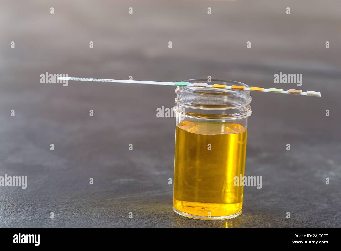 Strip of ph paper resting on specimen, with comparison chart box Stock ...