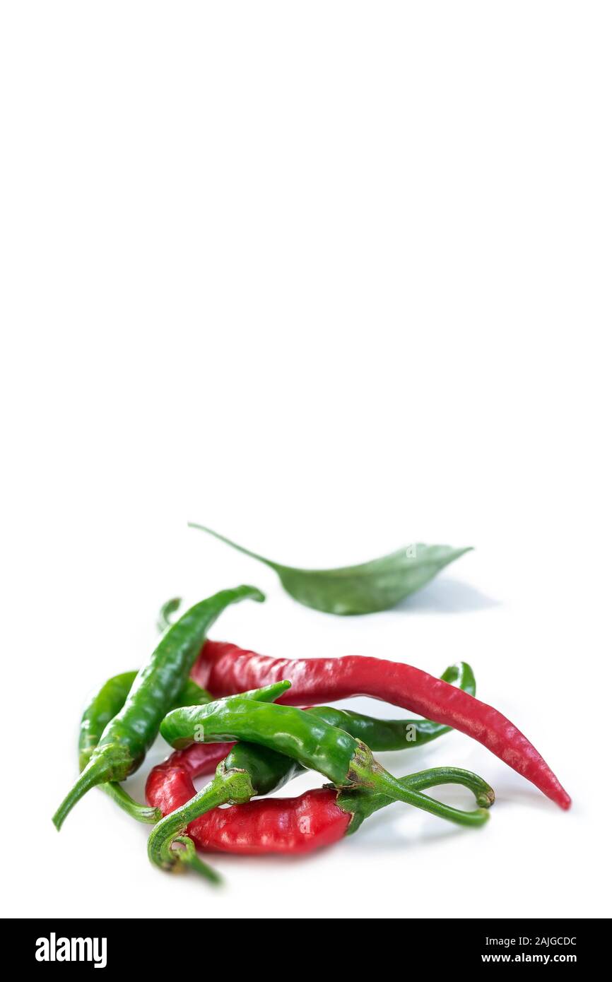 Red and green chilli peppers on white background Stock Photo - Alamy