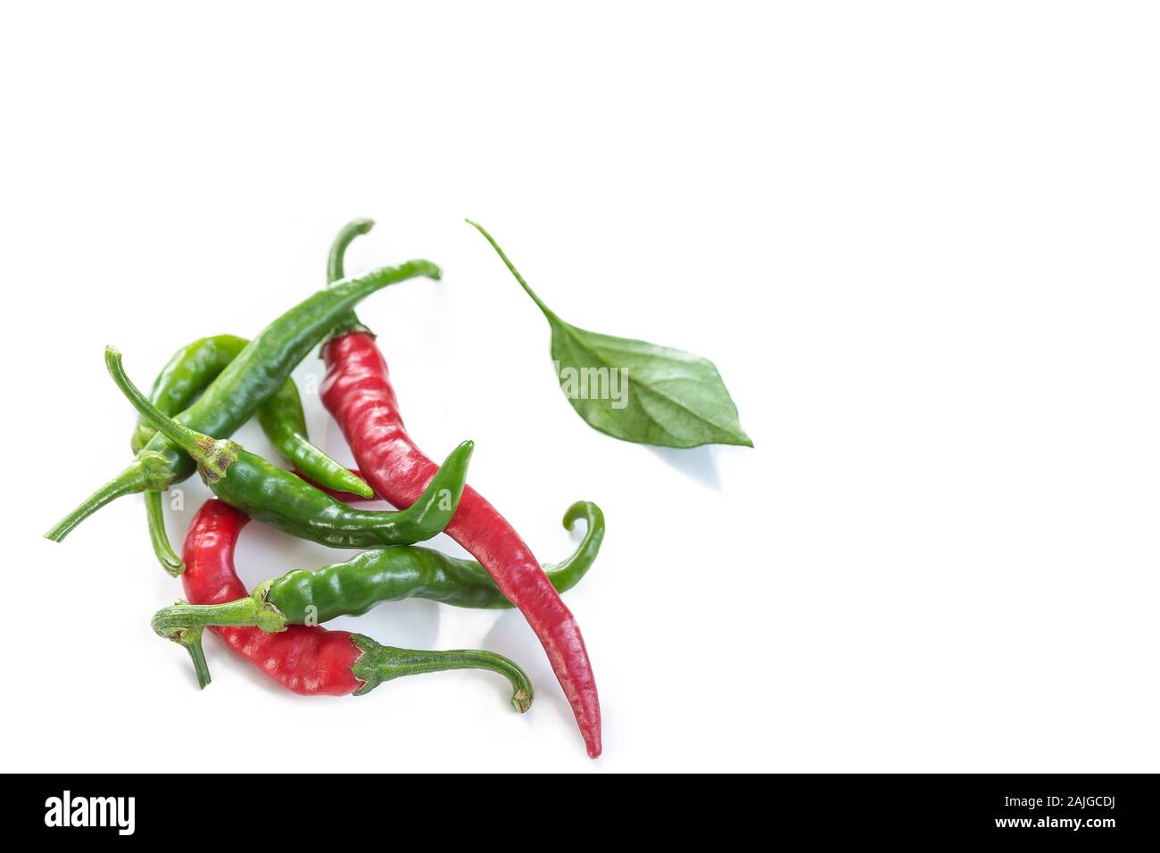 Red and green chilli peppers on white background Stock Photo - Alamy