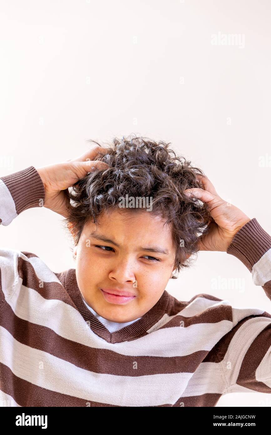 Boy scratching his head, looking annoyed on white background Stock ...