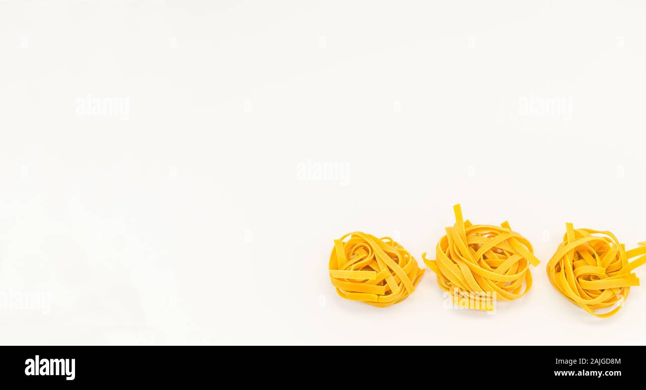 italian tagliatelle pasta nests on a white background - natural food ...