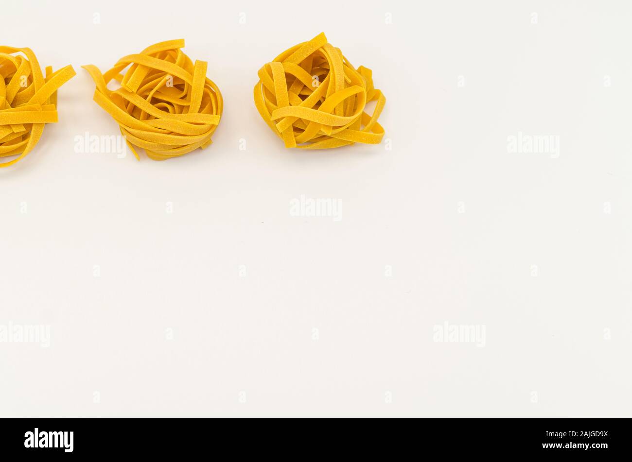 italian tagliatelle pasta nests on a white background - natural food ...