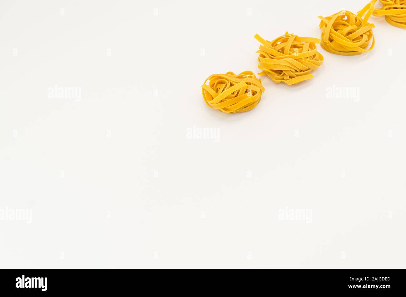 italian tagliatelle pasta nests on a white background - natural food ...