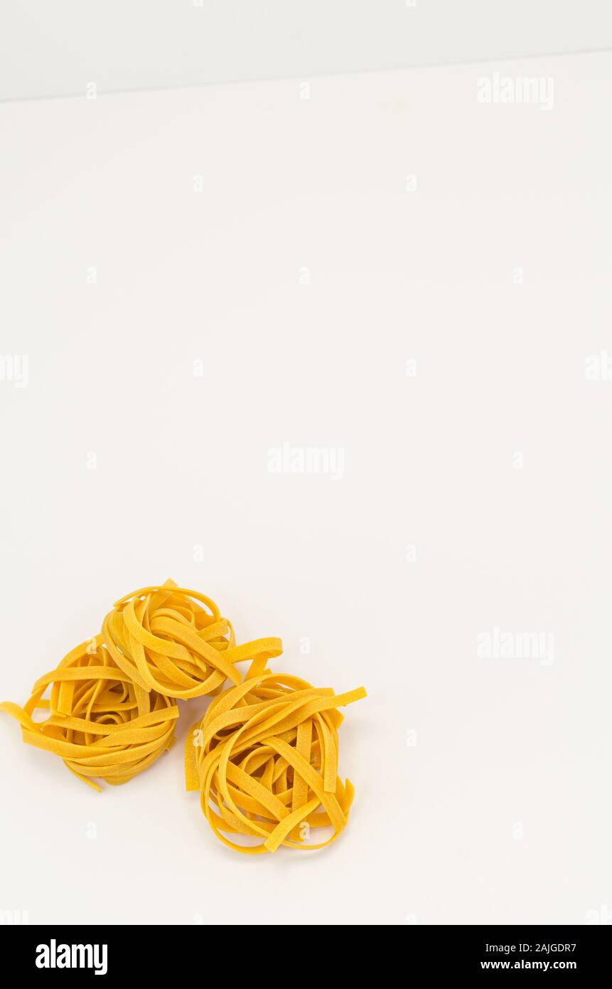 italian tagliatelle pasta nests on a white background - natural food ...