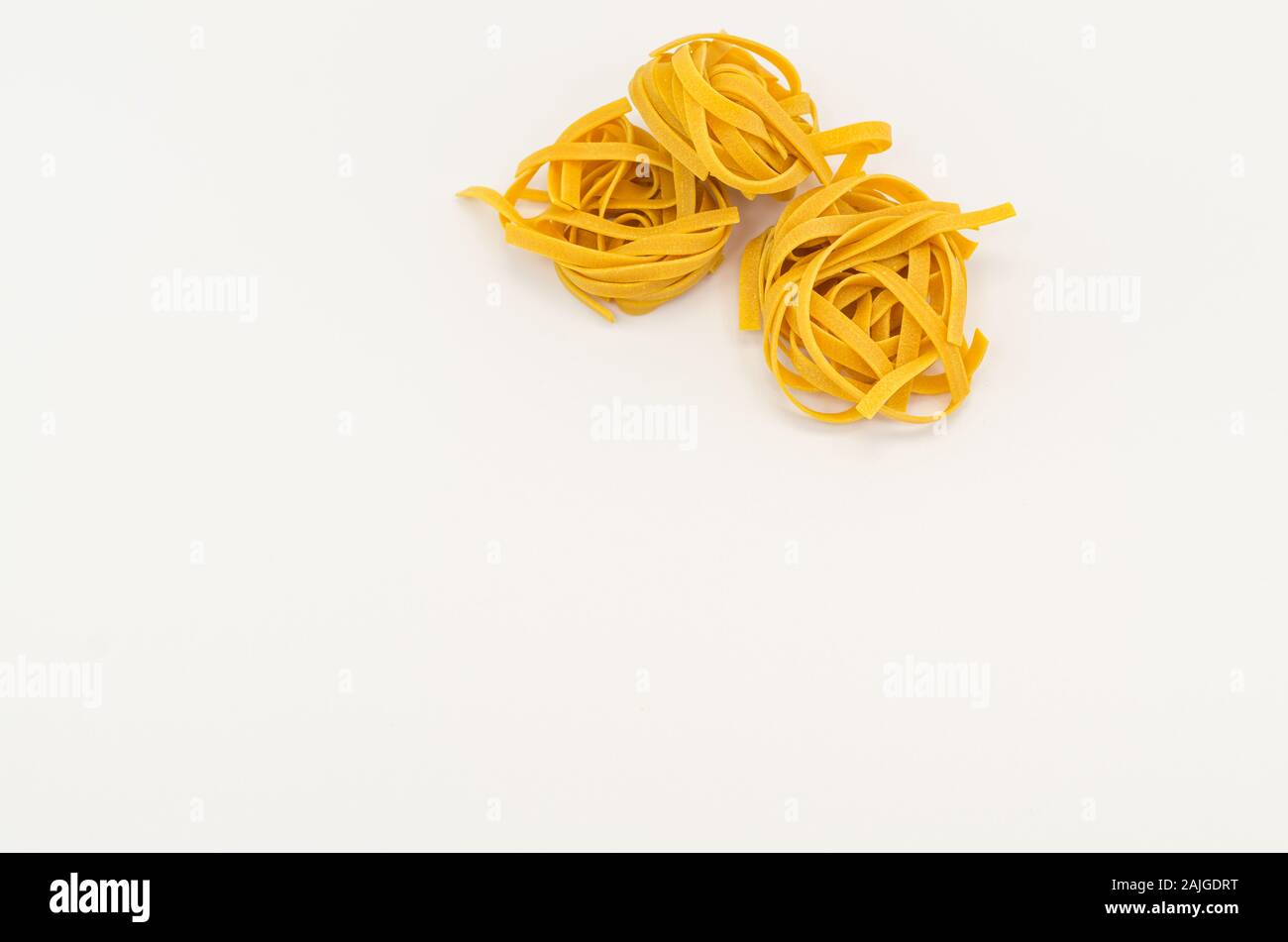 italian tagliatelle pasta nests on a white background - natural food ...