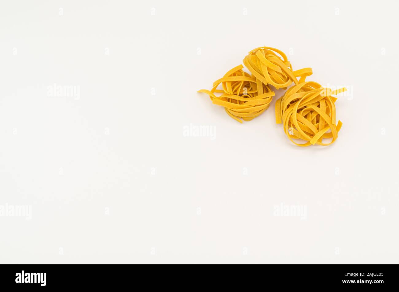 italian tagliatelle pasta nests on a white background - natural food ...