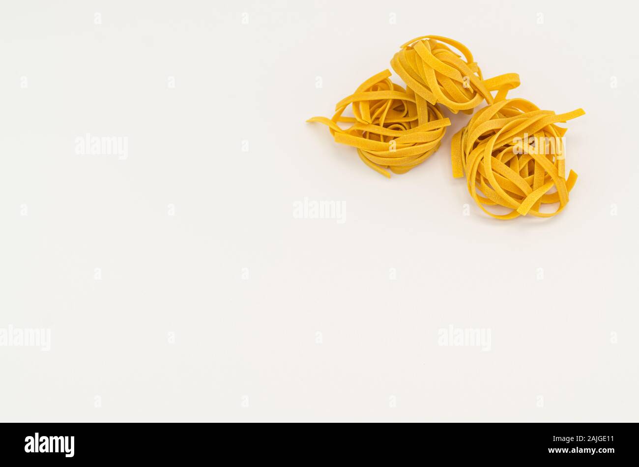 italian tagliatelle pasta nests on a white background - natural food ...