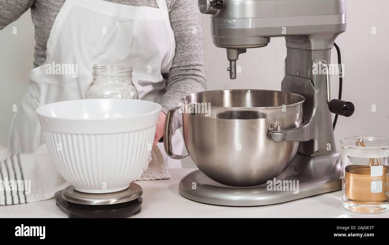 Step by step. Flat lay. Mixing royal icing in electric kitchen mixer ...