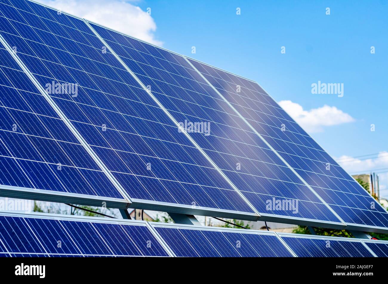 Solar panels on blue sky background Stock Photo - Alamy
