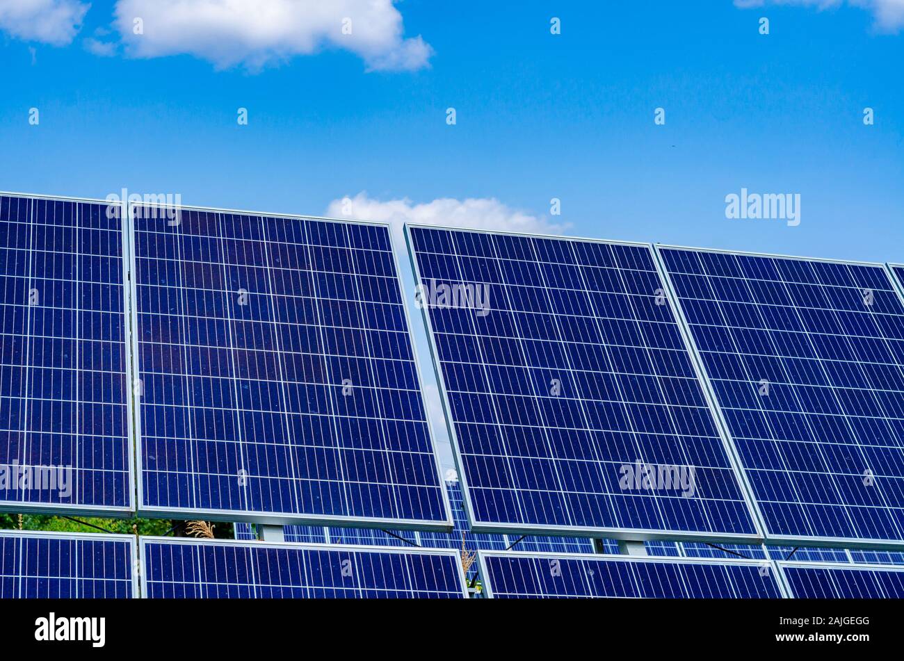 Solar panels on blue sky background Stock Photo - Alamy